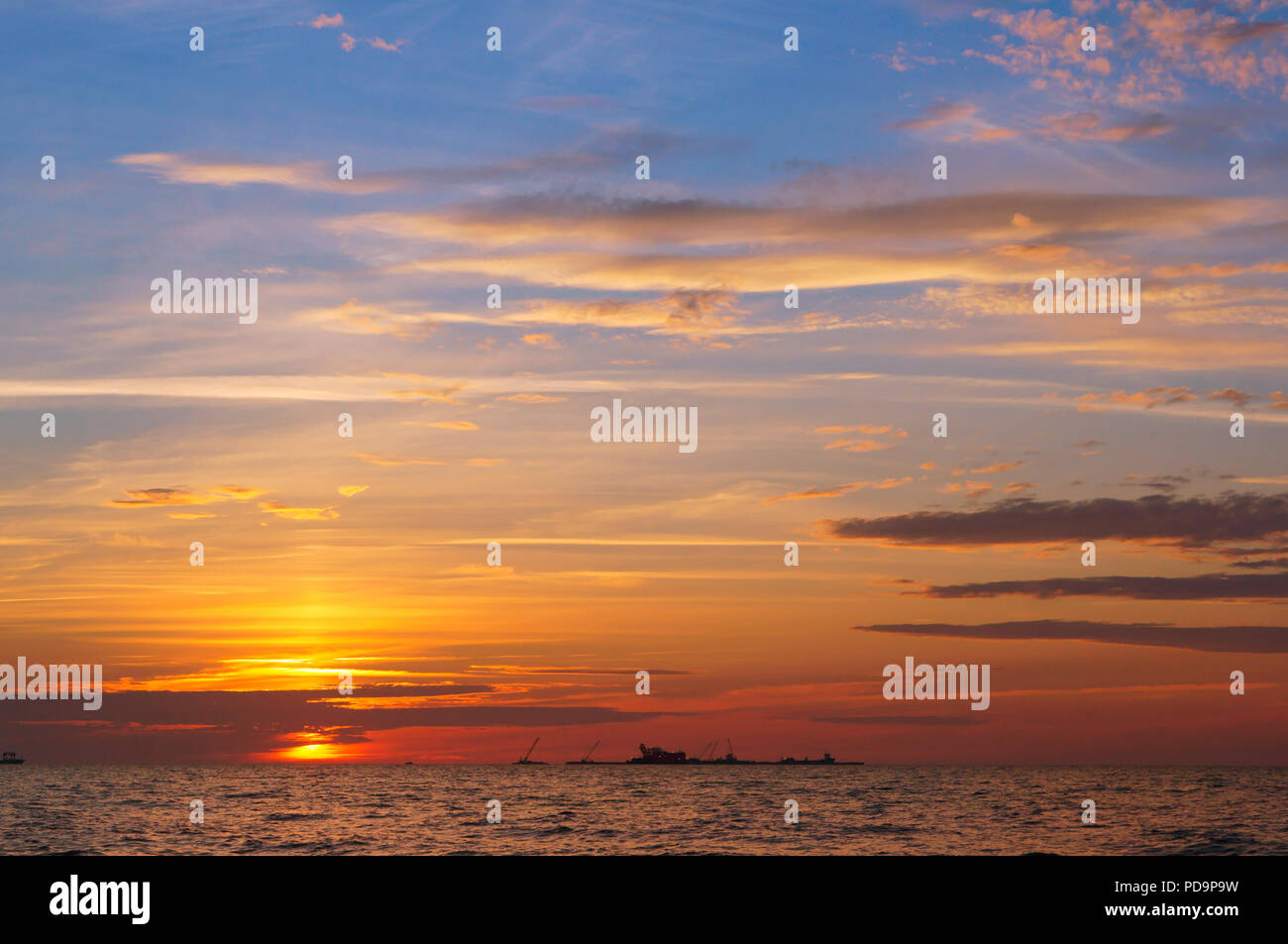 Sunset over the sea. Reflection of sunlight in the sea waves. Red sky ...