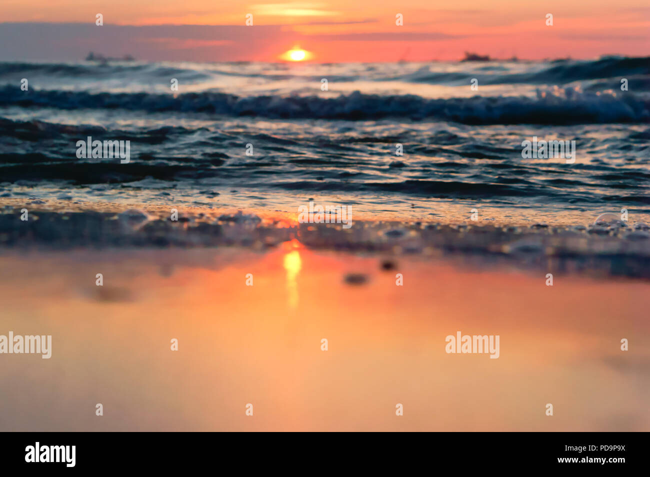 Sunset over the sea. Reflection of sunlight in the sea waves. Red sky ...