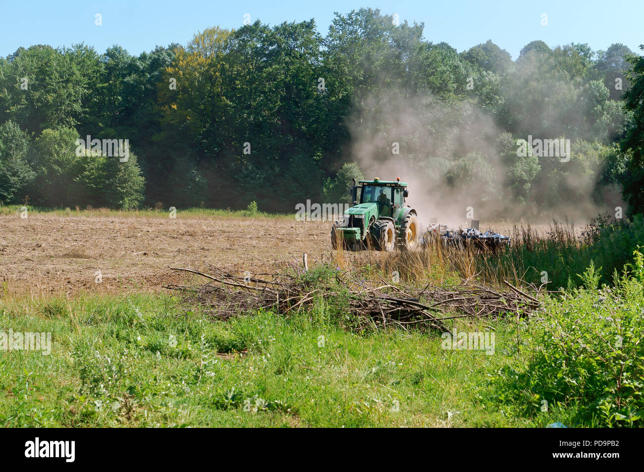 tractor plowing the land, agricultural machine working in the field ...