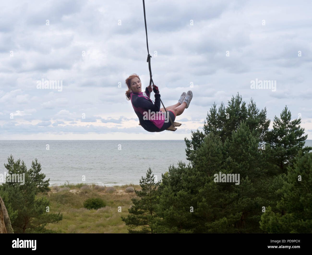Girl swinging on rope swing hi-res stock photography and images - Alamy