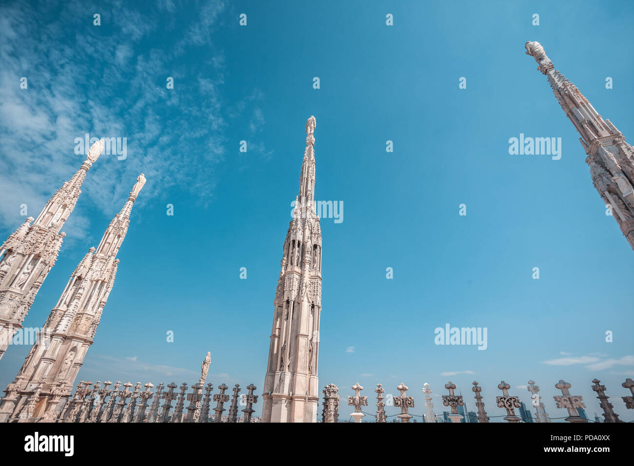 view of Gothic architecture and art on the roof of Milan Cathedral ...