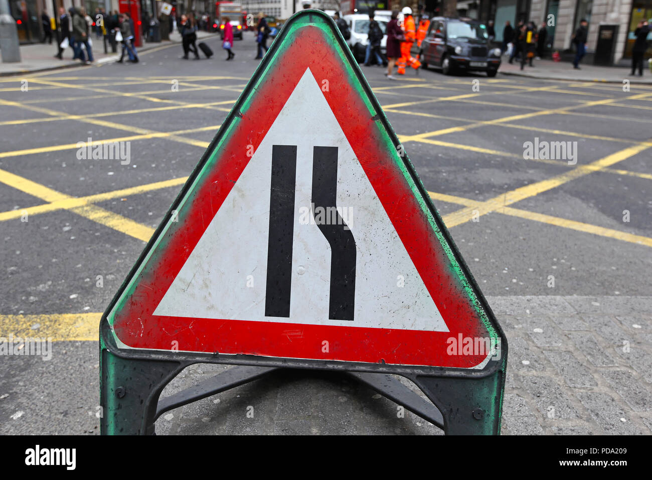 Road narrows traffic sign at the street intersection Stock Photo - Alamy