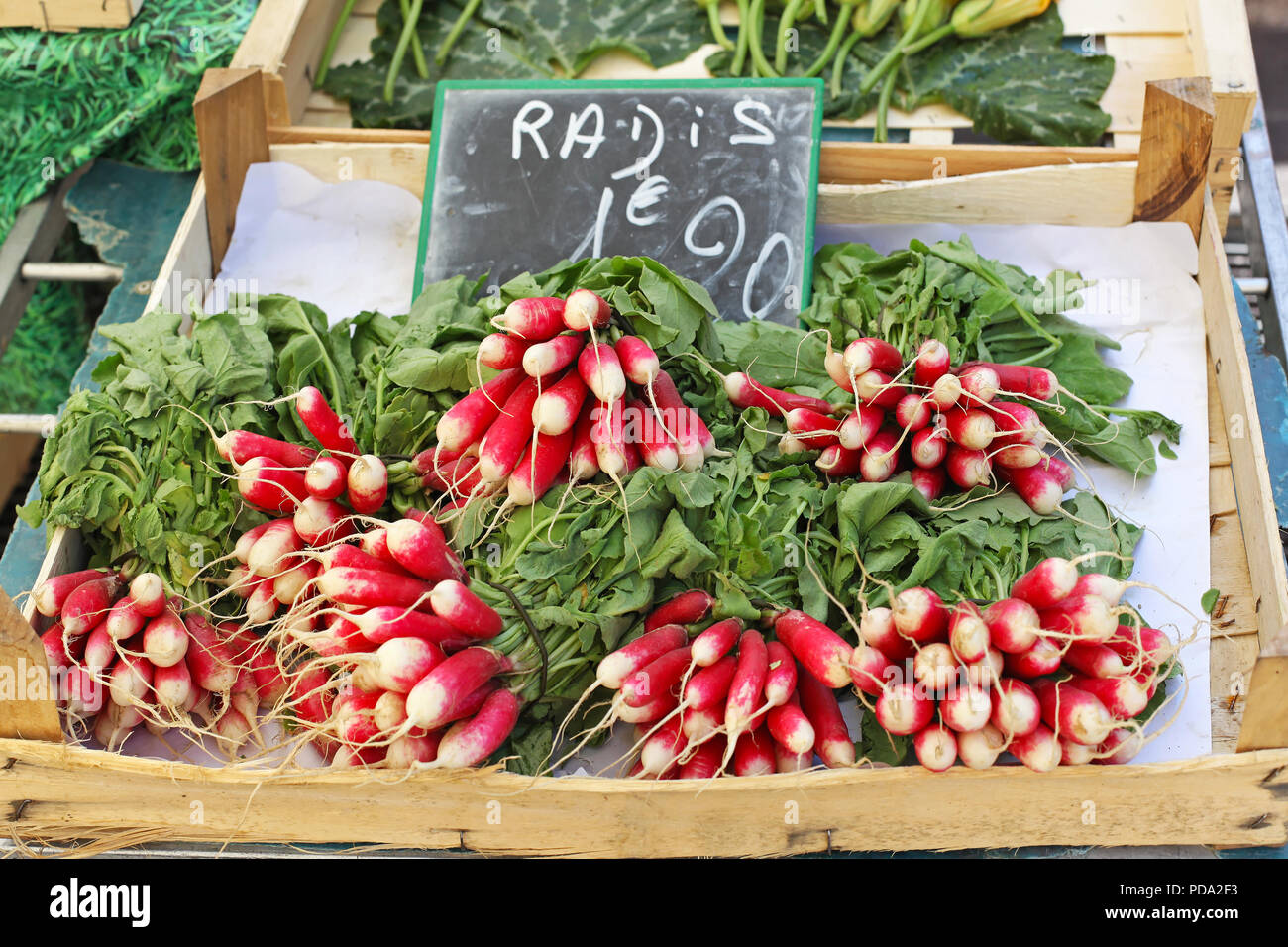 Red radishes in crate at farmers market Stock Photo - Alamy