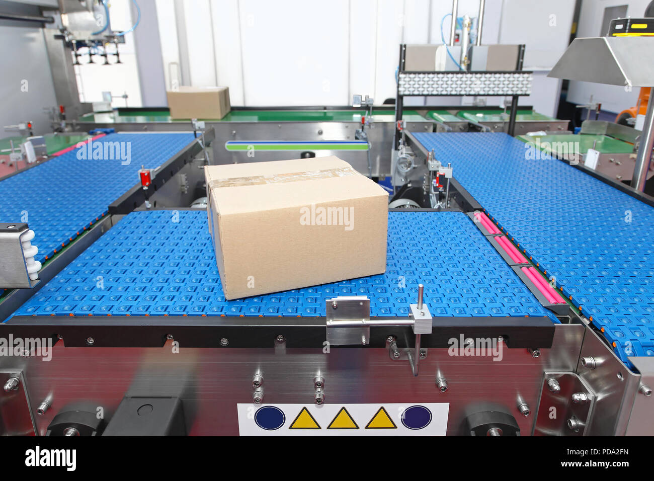 Packaging and handling goods at at conveyor system Stock Photo - Alamy