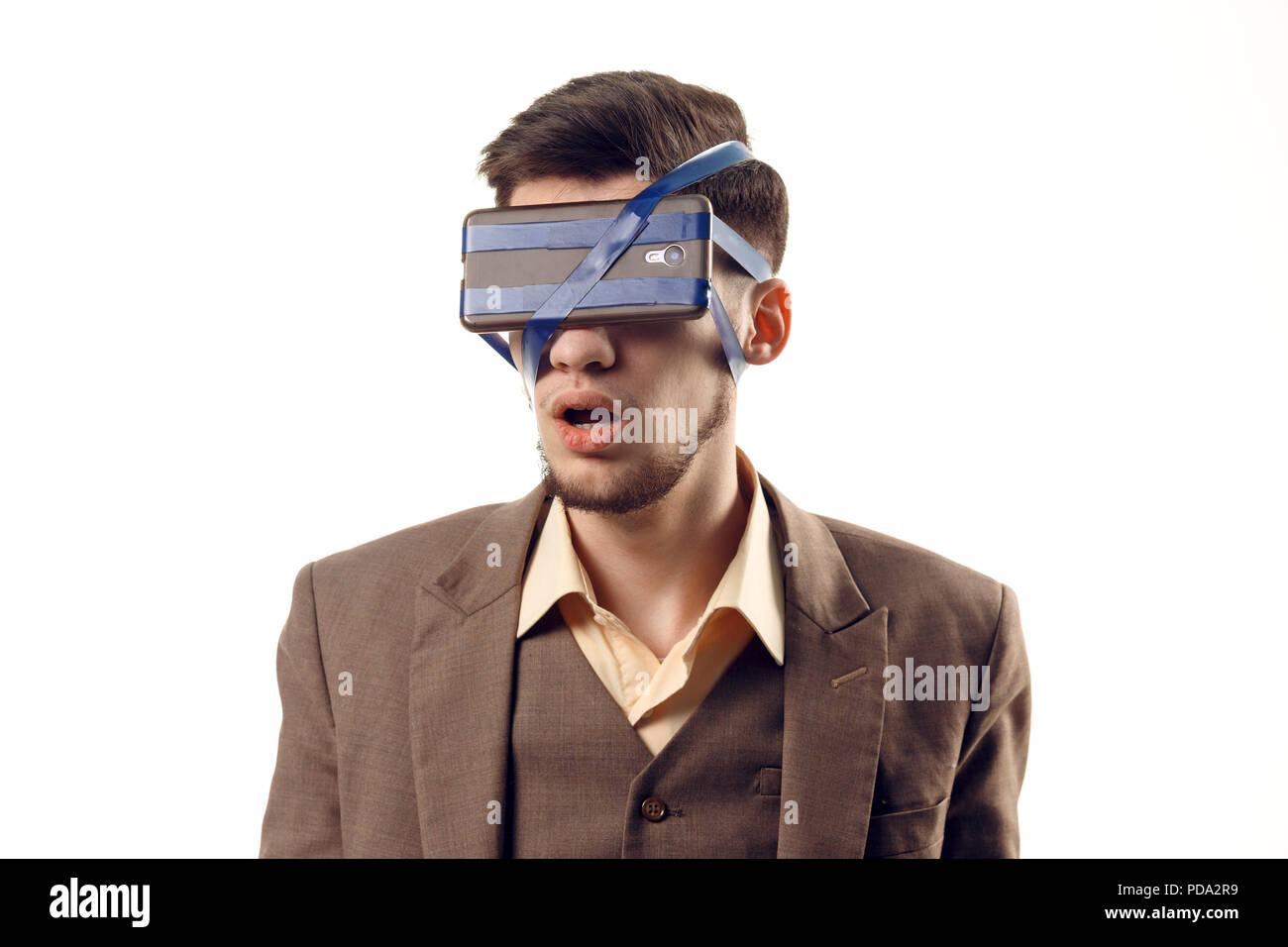 A humorous photo of modern technologies. Young guy with a phone ...