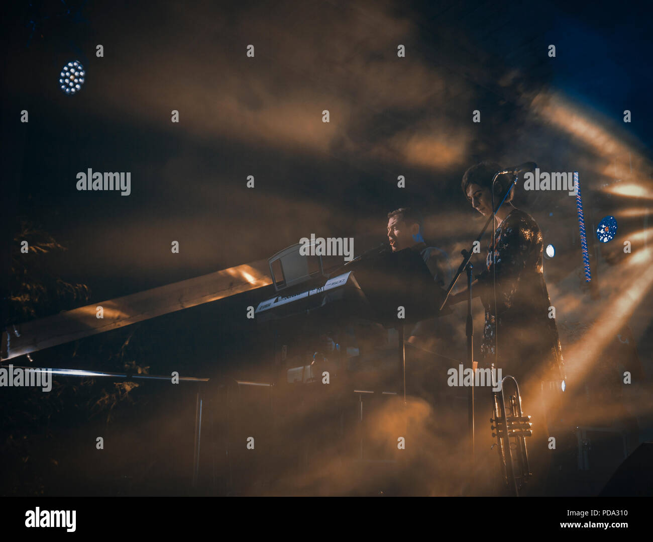 Band in yellow stage lights Stock Photo - Alamy