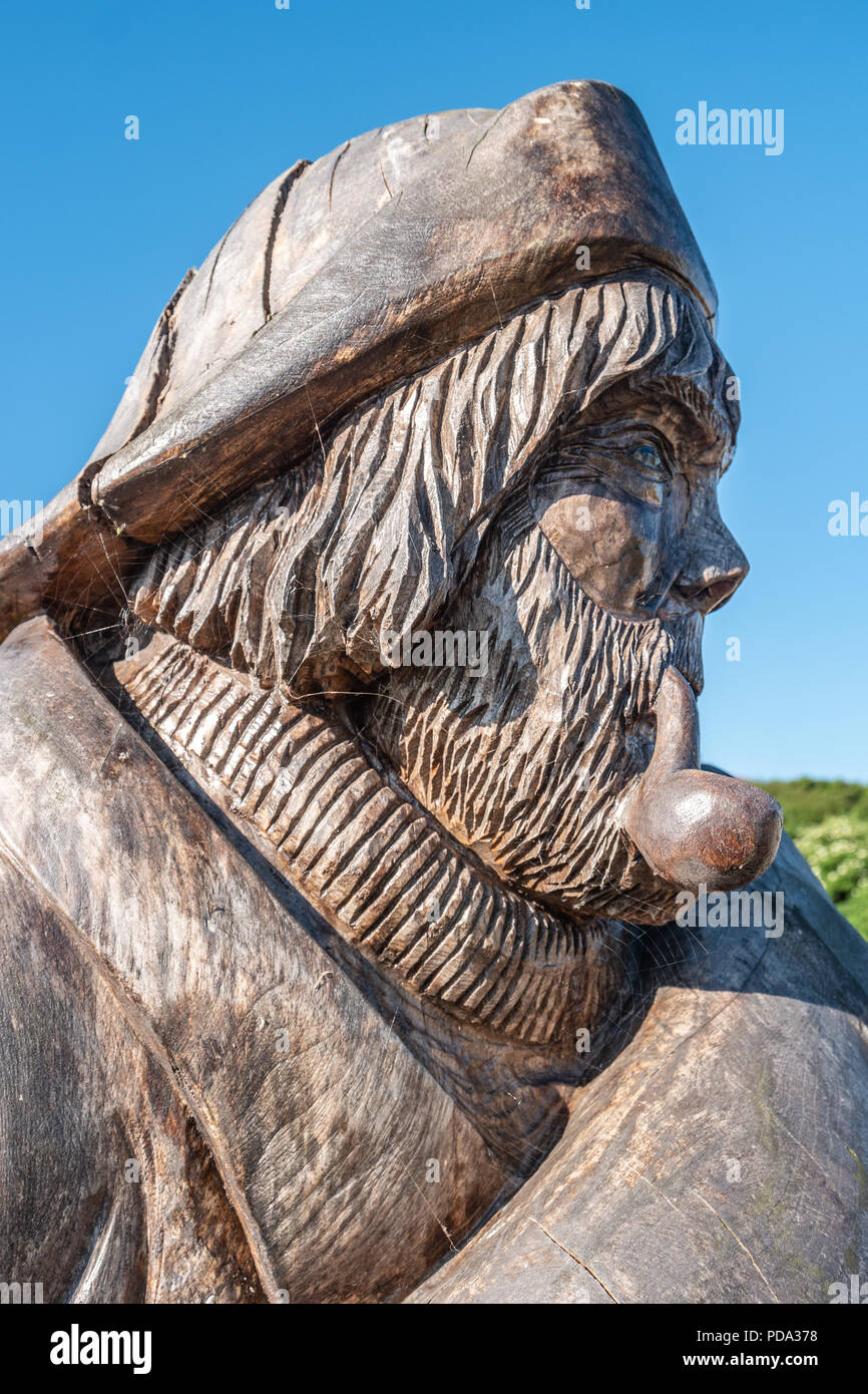 Portrait of old bearded fishman with smoking pipe realized in wooden ...