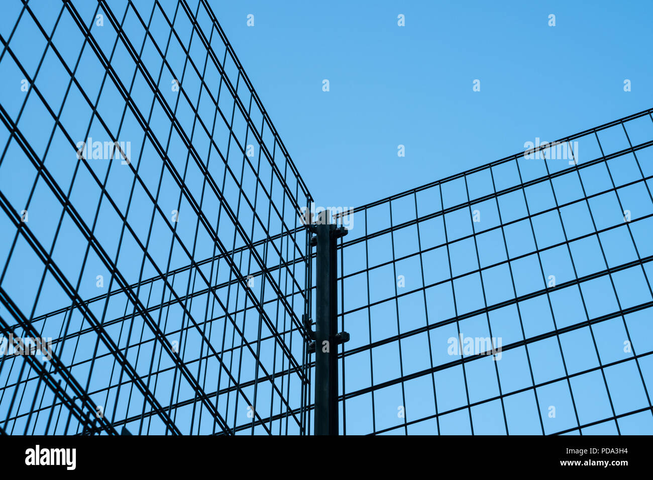 metal fence on blue sky - metal grid construction Stock Photo - Alamy