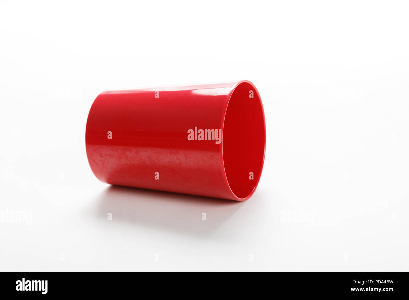 a red plastic mug with white background Stock Photo - Alamy