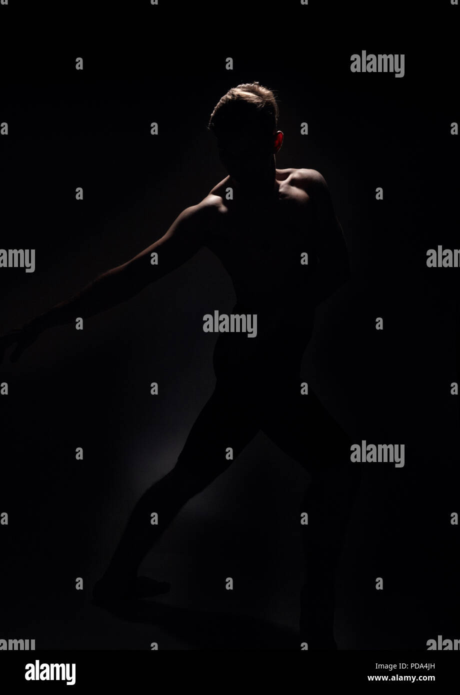 one ballet dancer, dark black background, backlit backlighting Stock ...