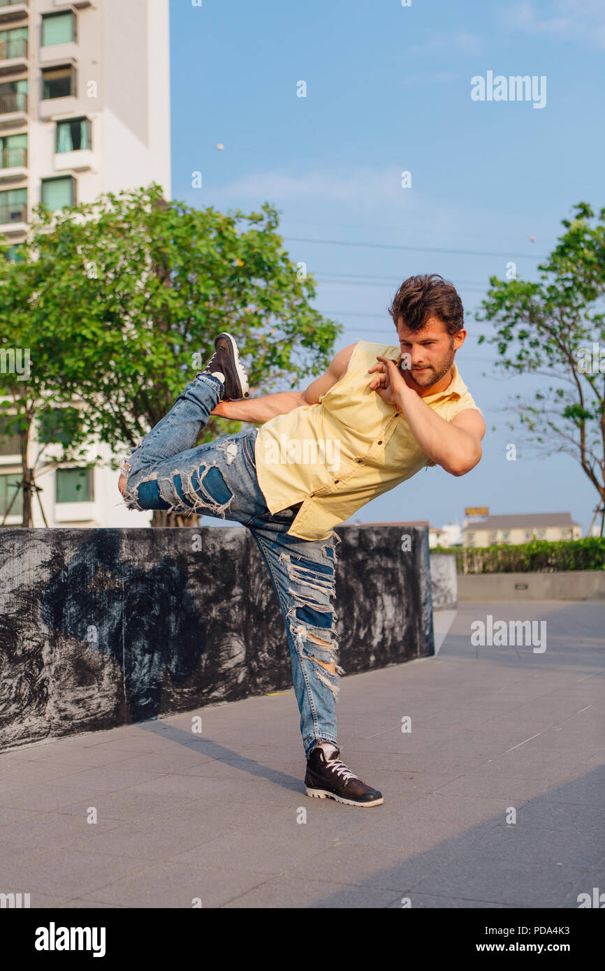 Young handsome man with beard dancing breakdance on the street Stock ...