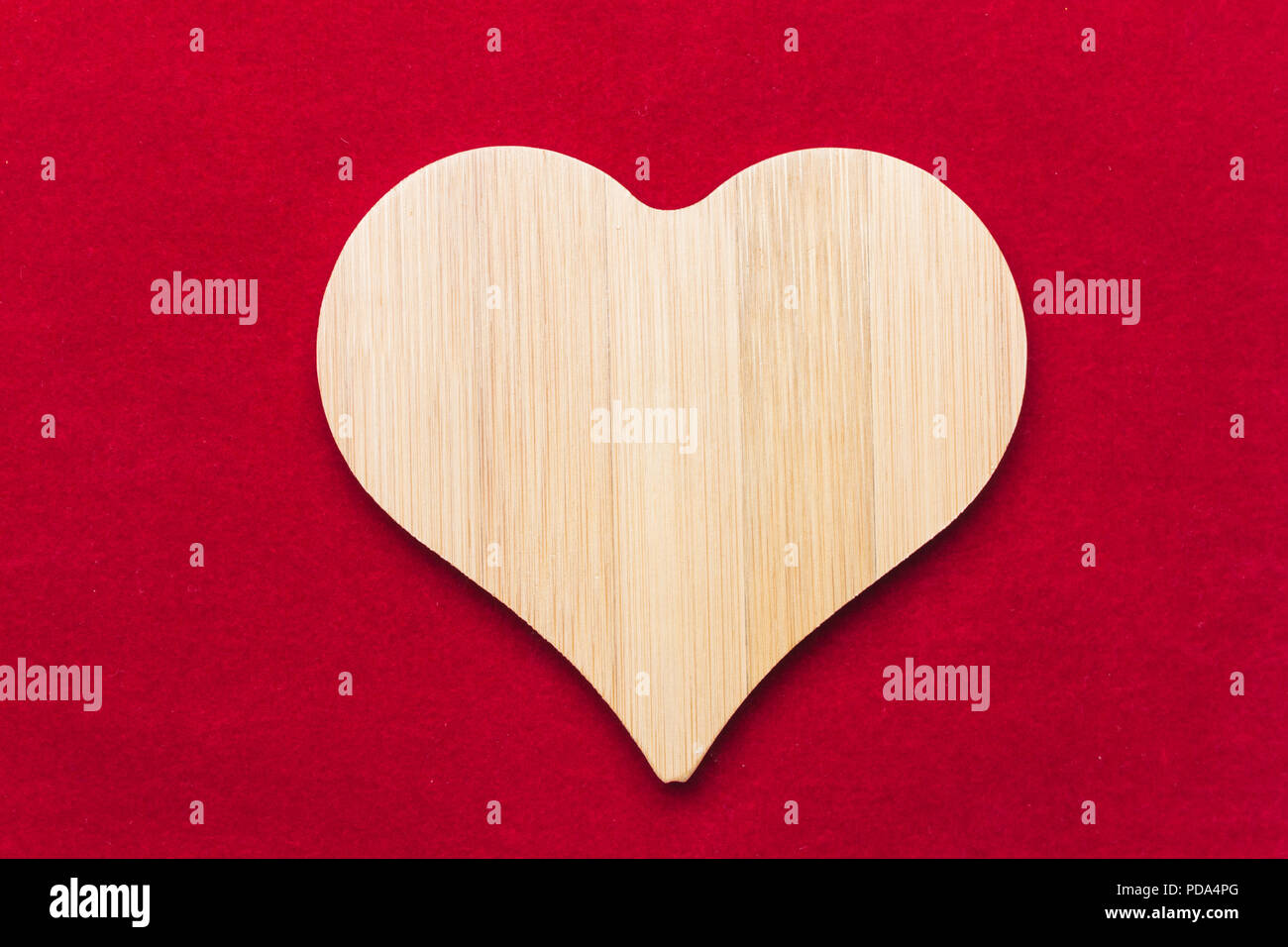 Heart shaped wood on red background Stock Photo - Alamy