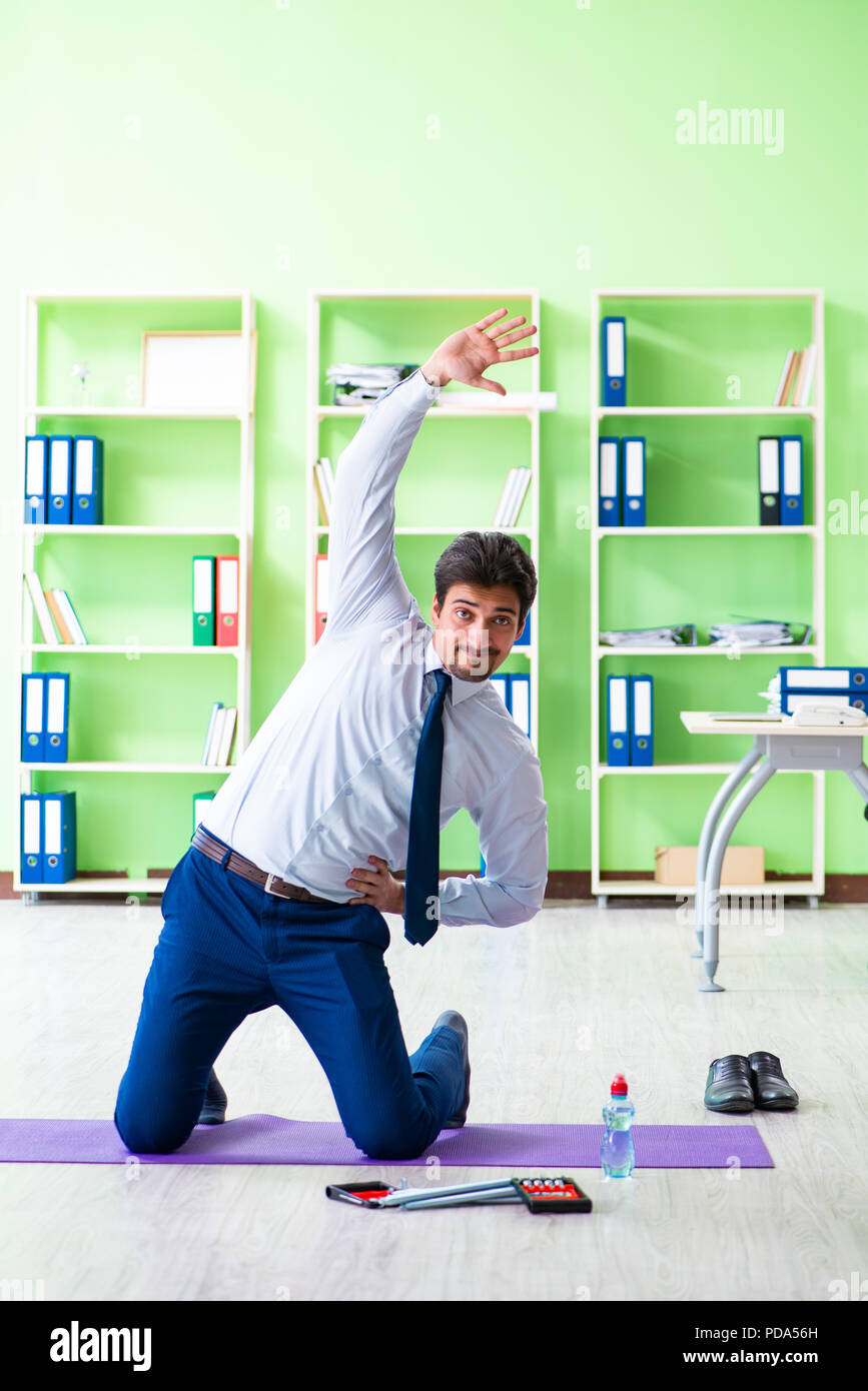 Employee doing exercises during break at work Stock Photo - Alamy