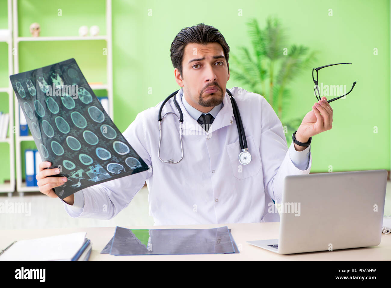 Doctor radiologist looking at x-ray scan in hospital Stock Photo - Alamy