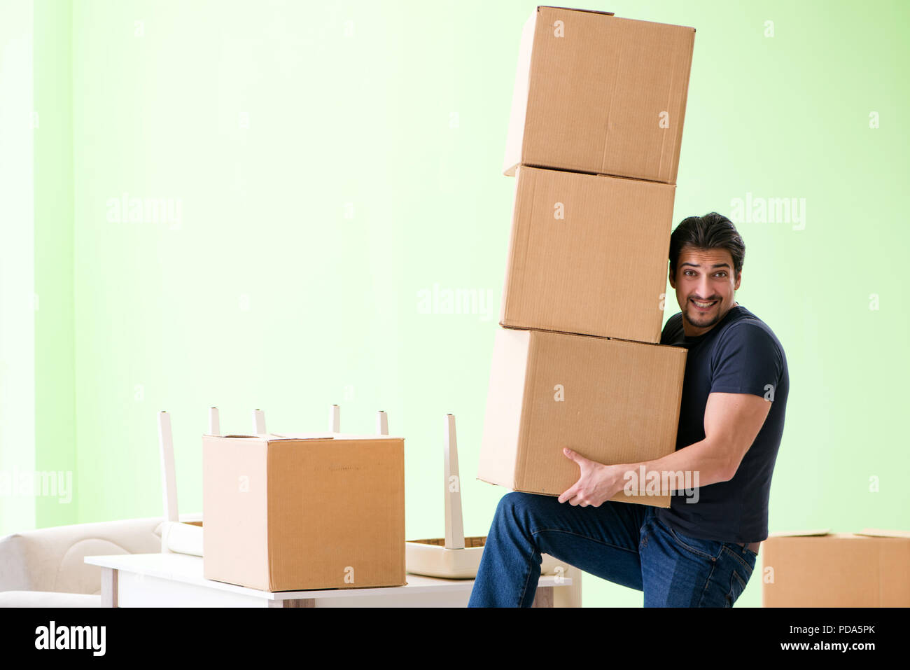 Man moving house with boxes Stock Photo - Alamy