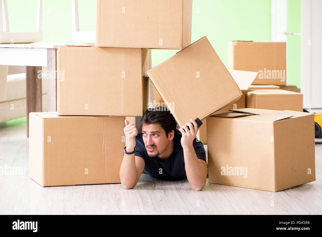 Man moving house with boxes Stock Photo - Alamy