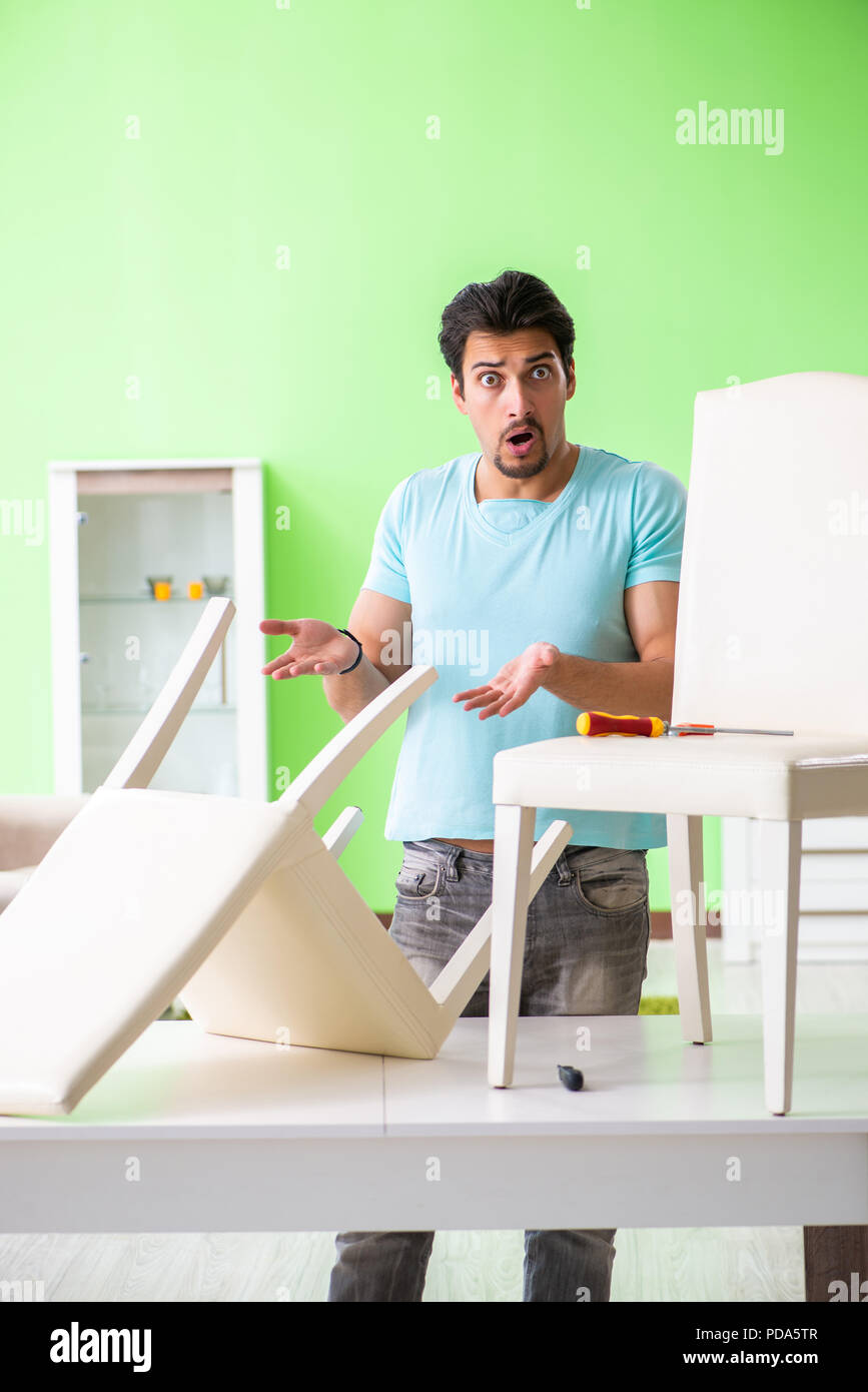 Man fixing leg table hi-res stock photography and images - Alamy