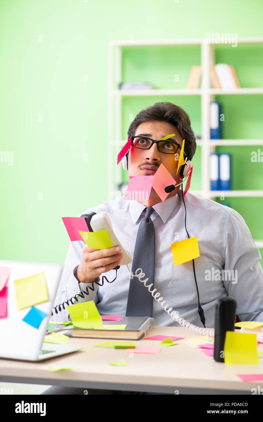 Young help desk operator working in office with many conflicting ...