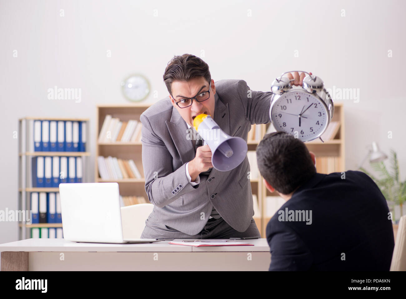Angry boss shouting at his employee Stock Photo - Alamy