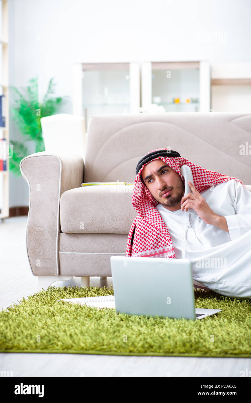 Arab man working at home on his work Stock Photo - Alamy