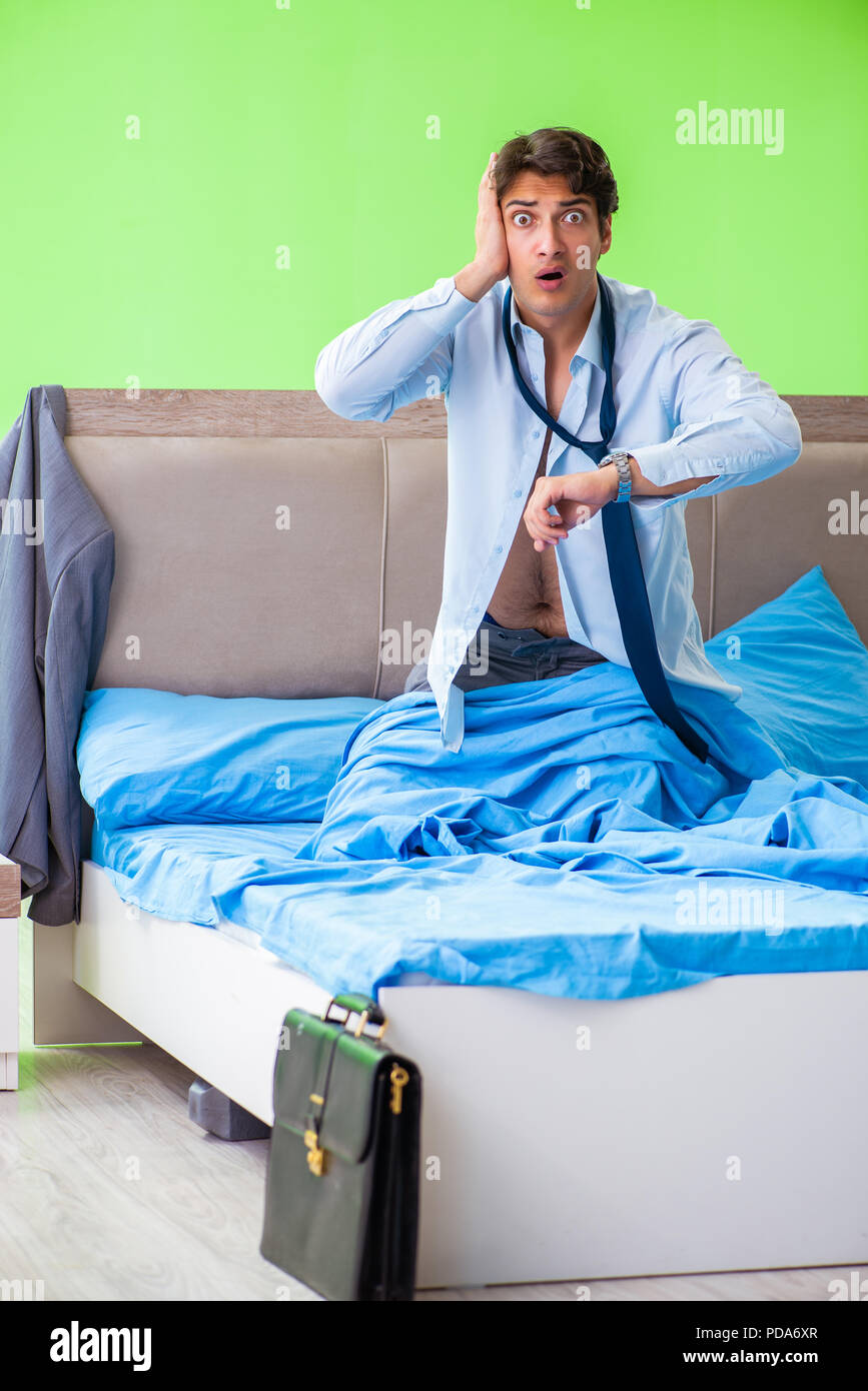 Employee in the bedroom being late for his job Stock Photo - Alamy