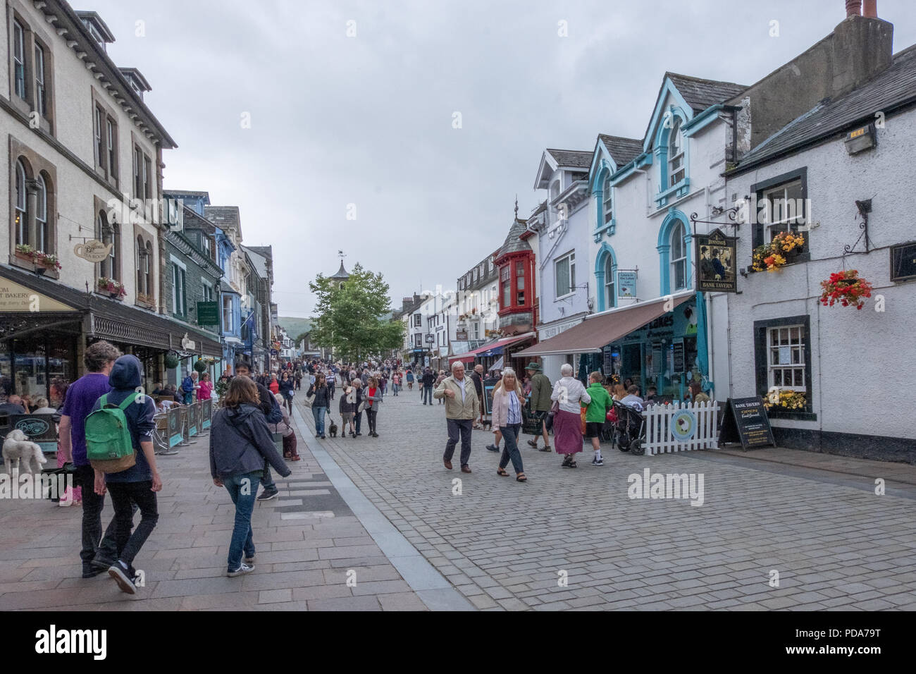 Main Street, the town centre of Keswick, Cumbria, uk with busy shoppers ...