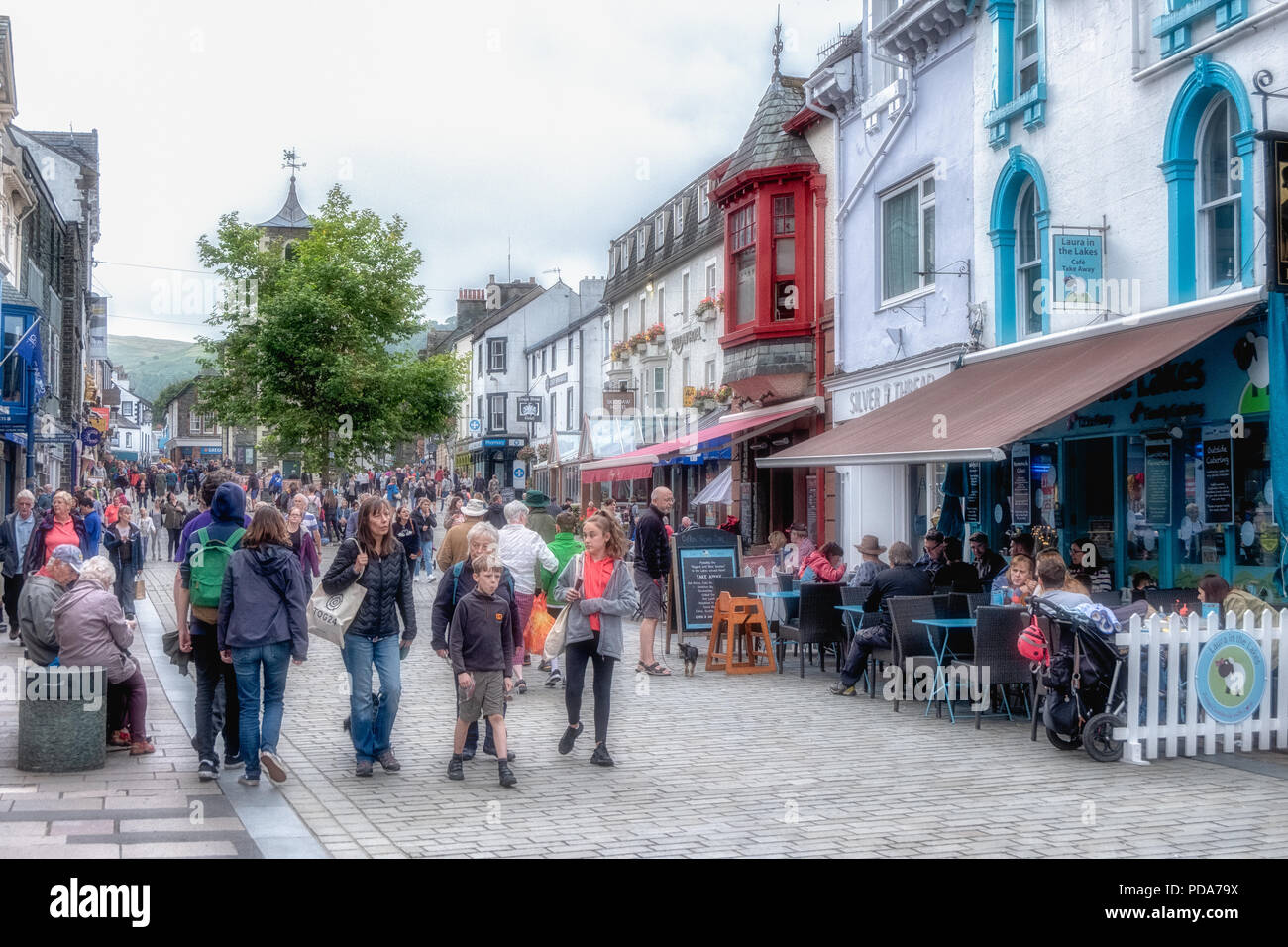 Main Street, the town centre of Keswick, Cumbria, uk with busy shoppers ...