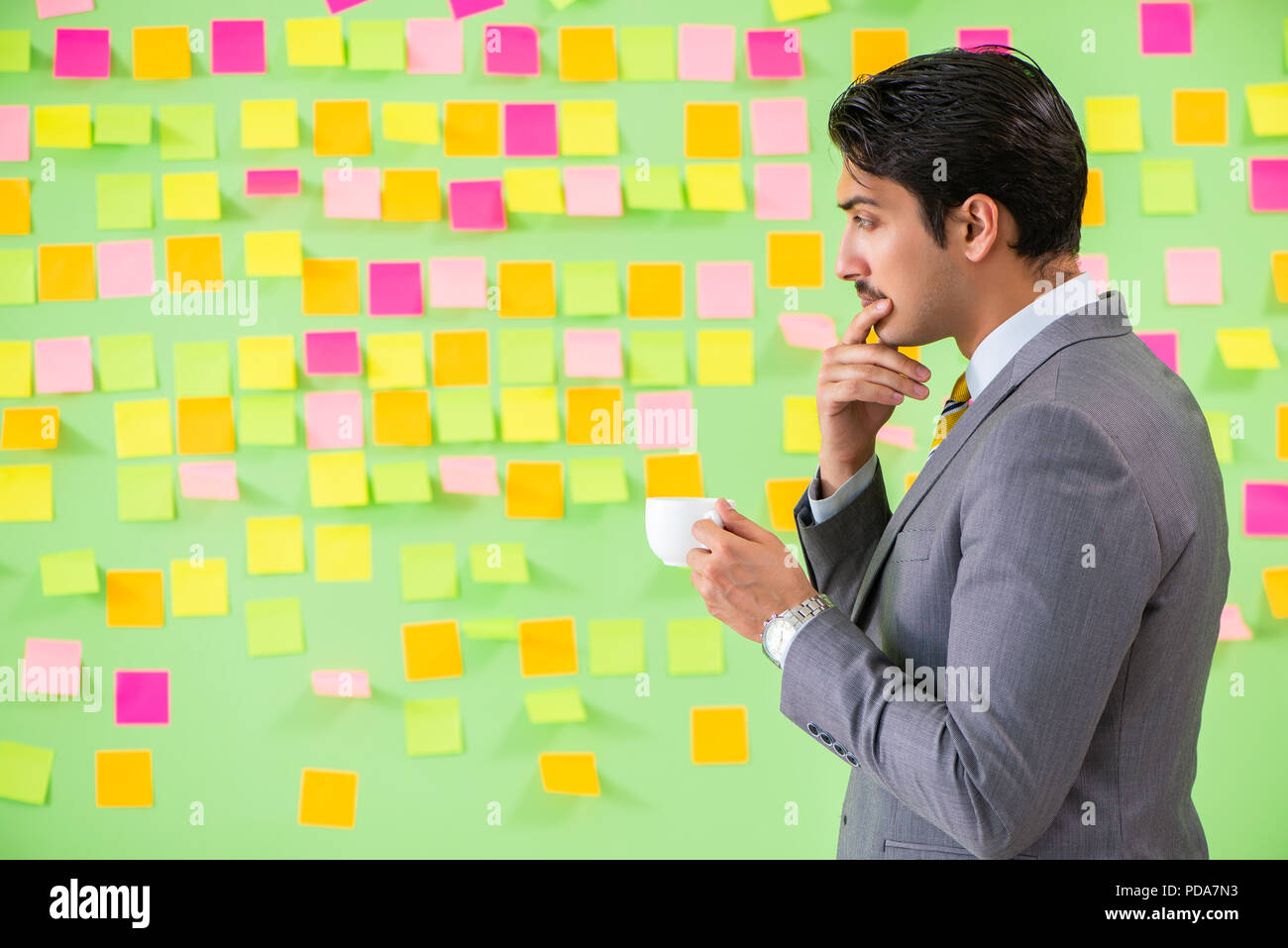 Businessman with many business priorities Stock Photo - Alamy