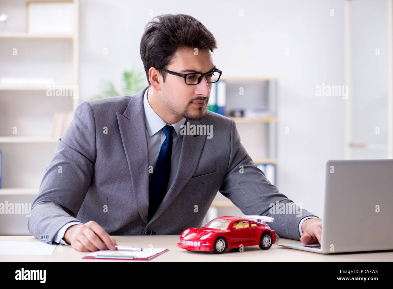 Agent offering car motor insurance Stock Photo - Alamy