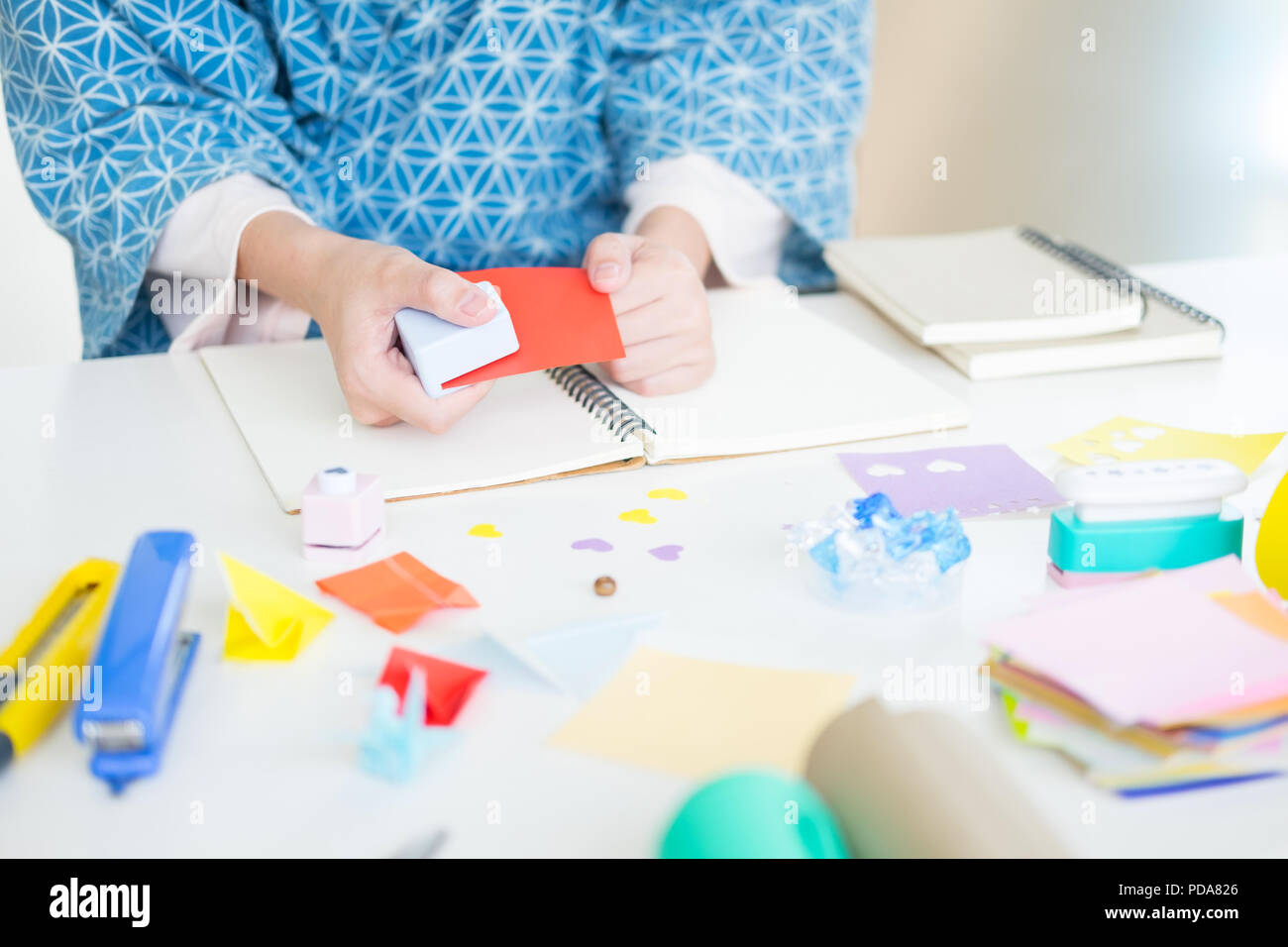 Woman's hand cut paper Making a scrap booking or other festive ...