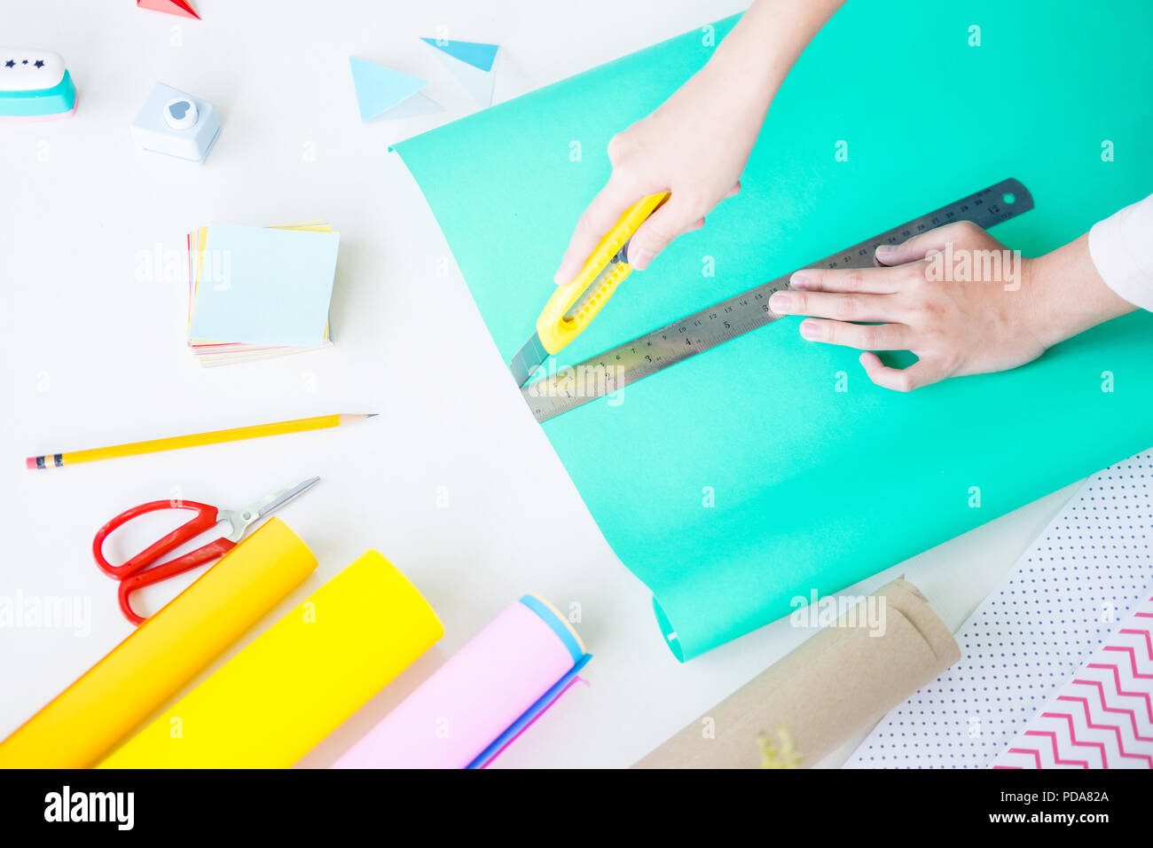 Woman's hand cut paper Making a scrap booking or other festive ...