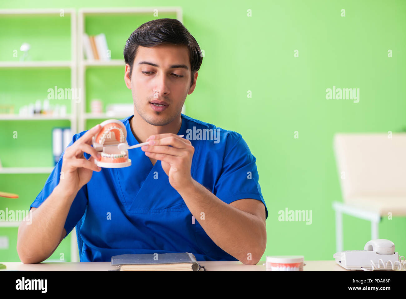 Man dentist working on new teeth implant Stock Photo - Alamy