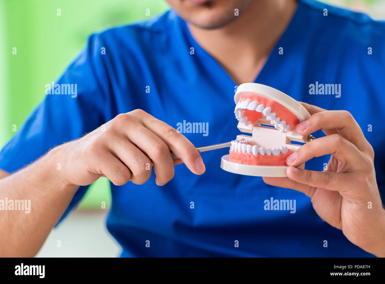 Man dentist working on new teeth implant Stock Photo - Alamy