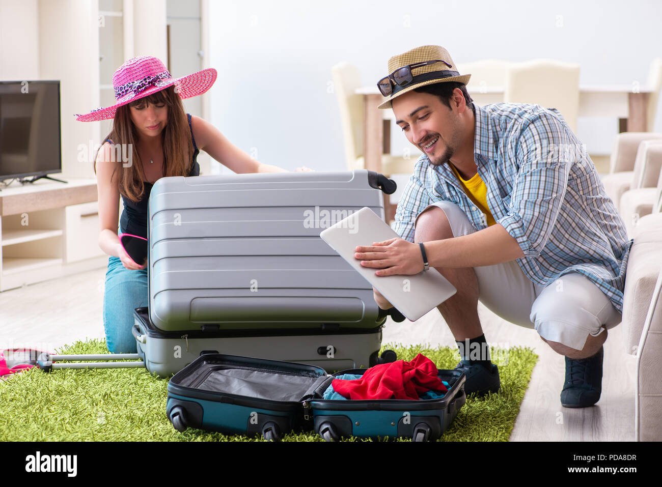 Young family packing for vacation travel Stock Photo - Alamy