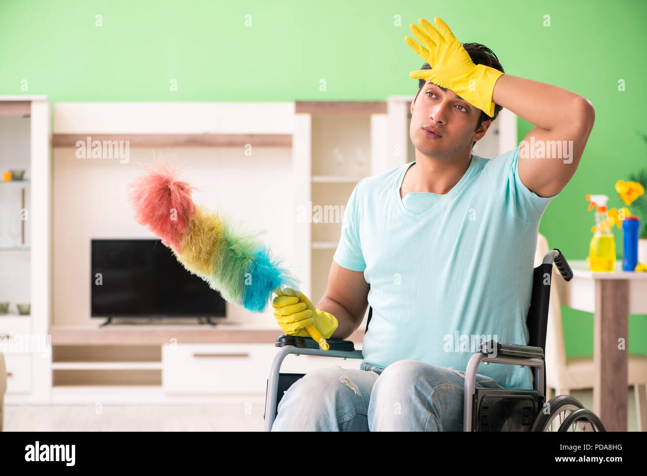 Disabled man on wheelchair cleaning house Stock Photo - Alamy