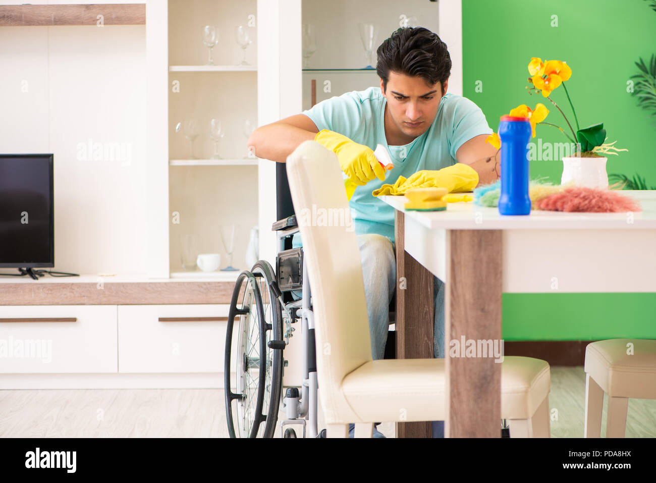 Disabled man on wheelchair cleaning house Stock Photo - Alamy