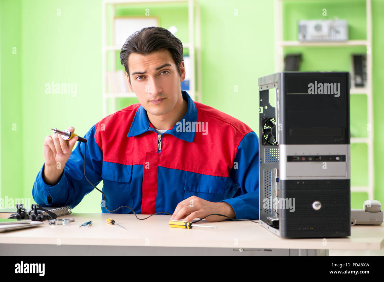 Computer engineer repairing broken desktop Stock Photo - Alamy