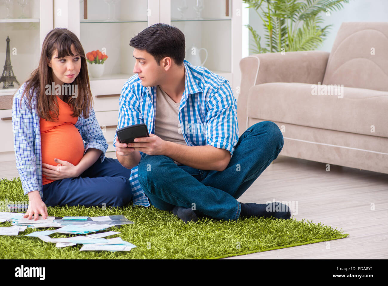 Young family in budget planning concept Stock Photo - Alamy