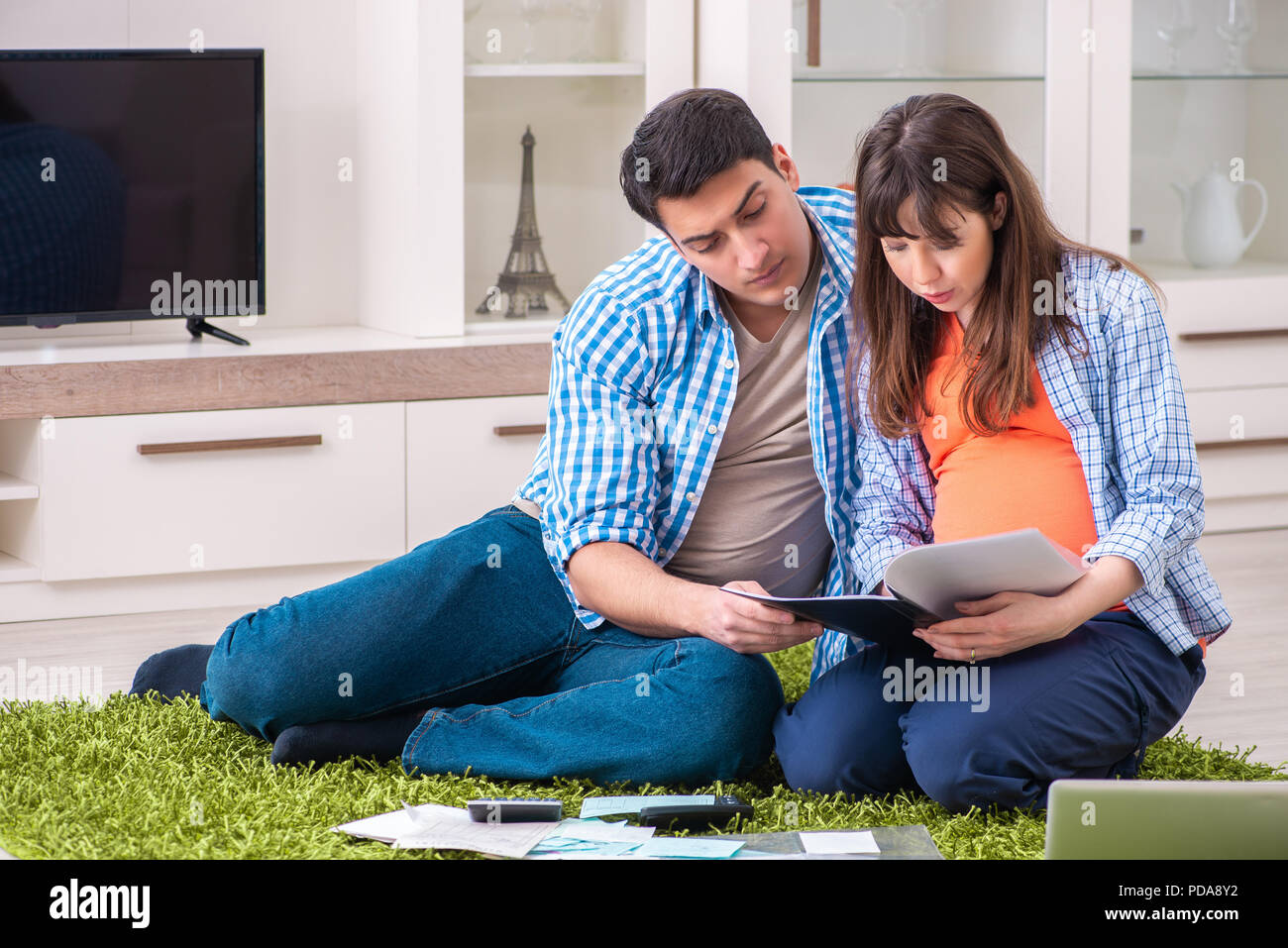Young family in budget planning concept Stock Photo - Alamy