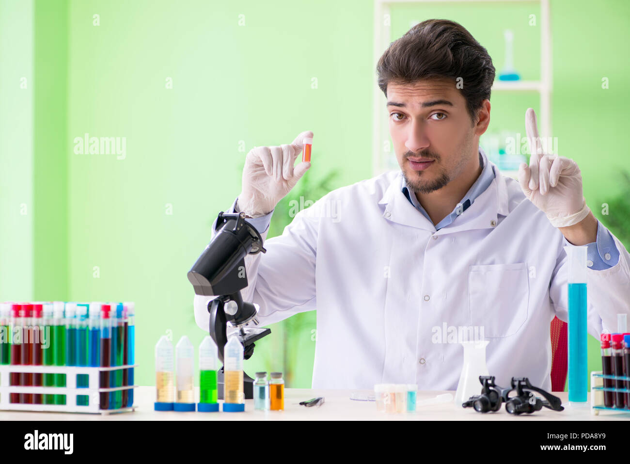 Man chemist working in the lab Stock Photo - Alamy