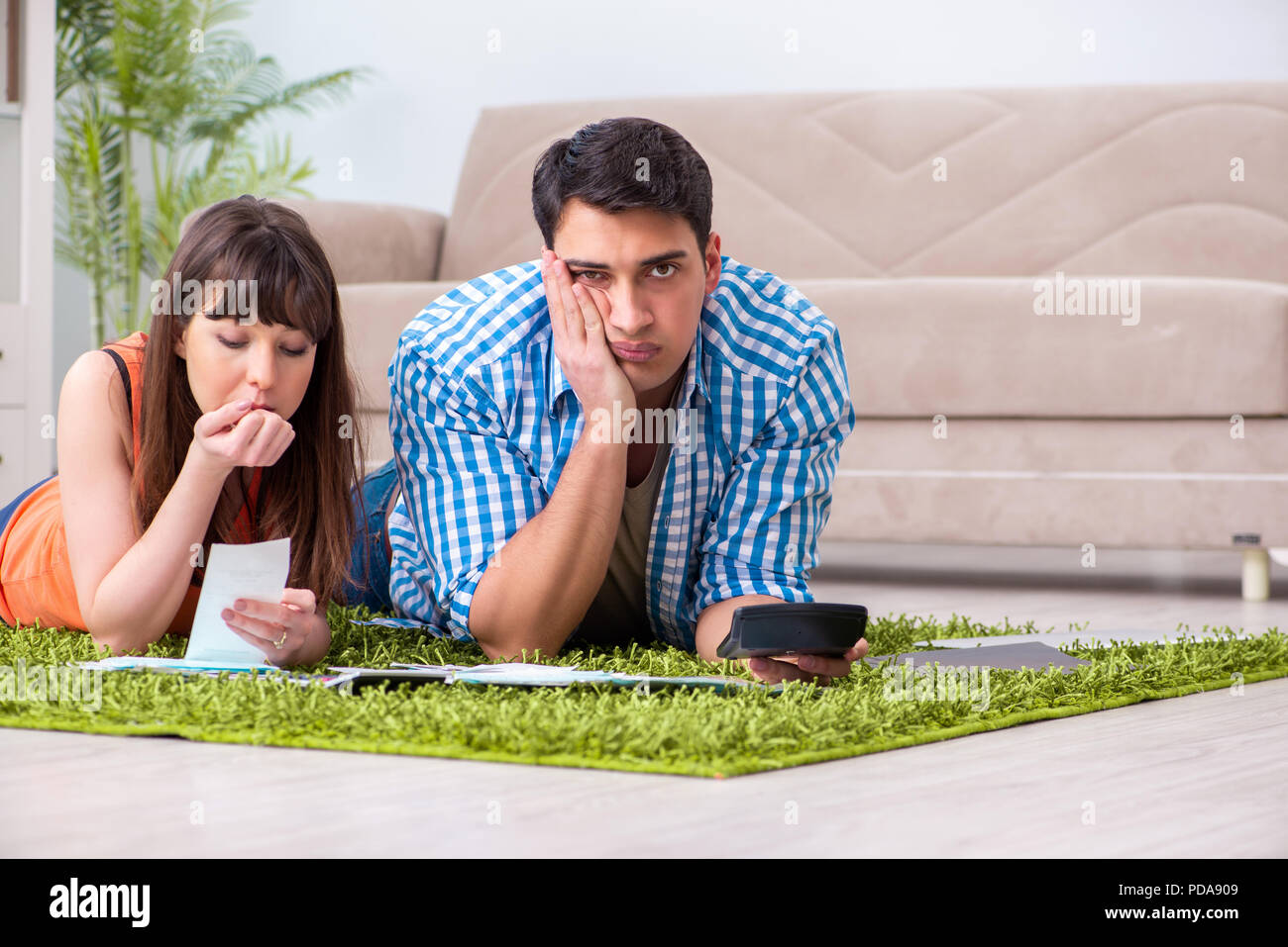 Young family in budget planning concept Stock Photo - Alamy