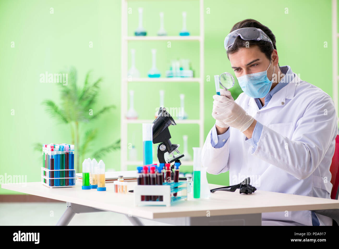 Man chemist working in the lab Stock Photo - Alamy
