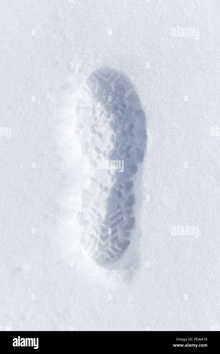 Foot imprint in fresh white snow, close-up top view Stock Photo - Alamy