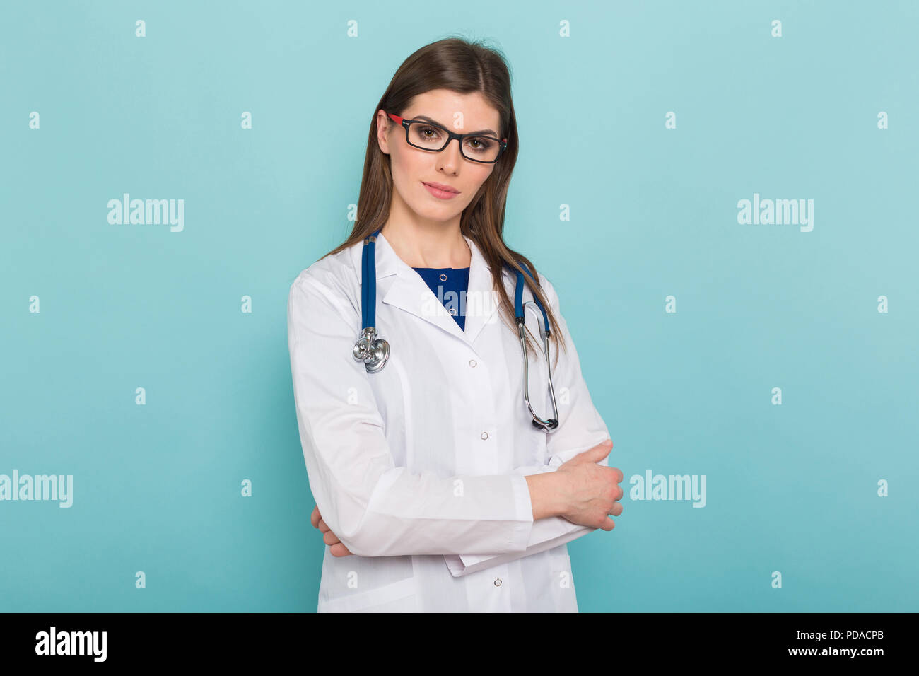 Attractive female doctor in white coat and glasses Stock Photo - Alamy