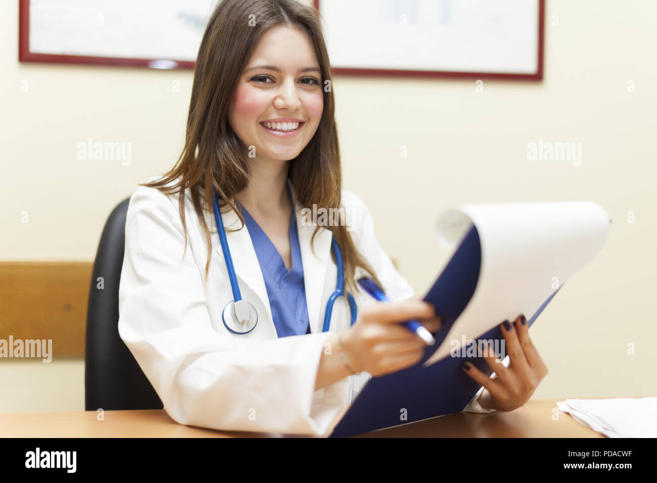 Doctor writing prescription smiling hi-res stock photography and images ...