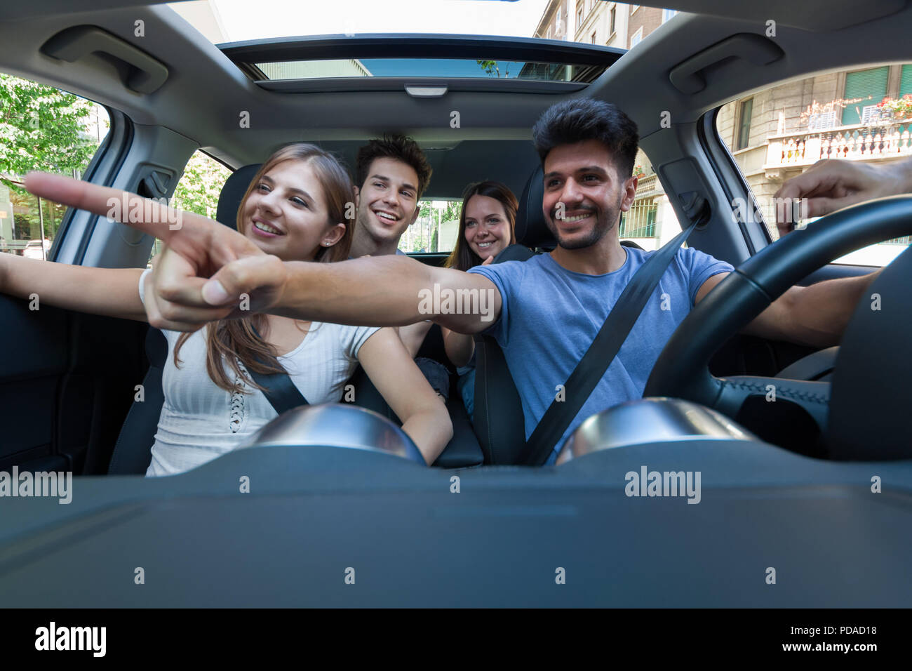 Group of happy friends on a car Stock Photo - Alamy