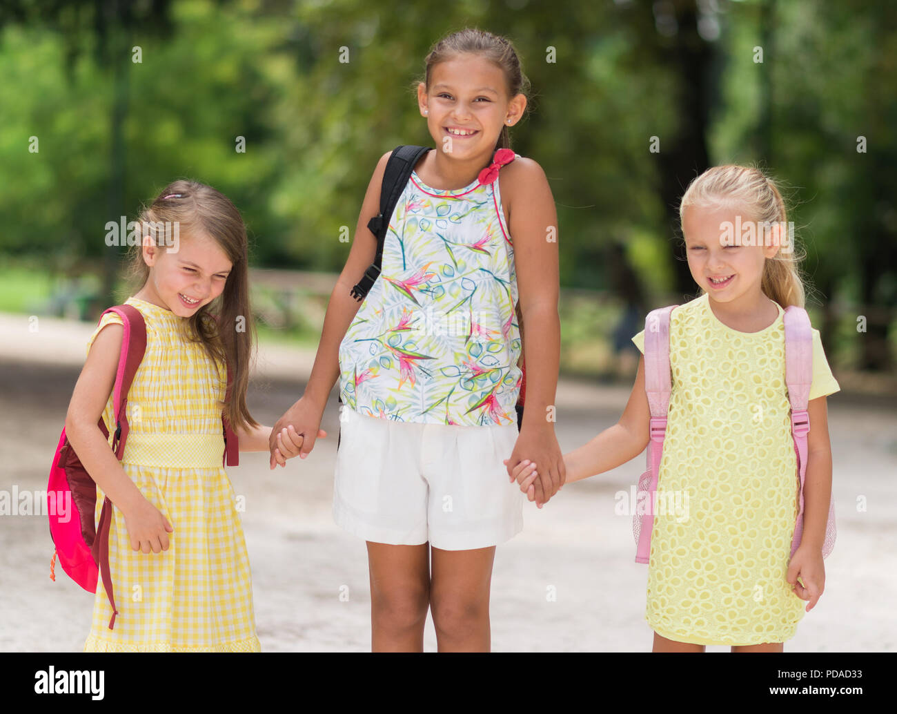 Happy girls going to school Stock Photo - Alamy