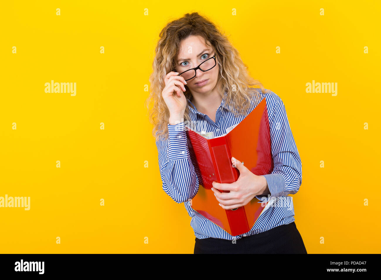 Woman in shirt with big folder Stock Photo - Alamy