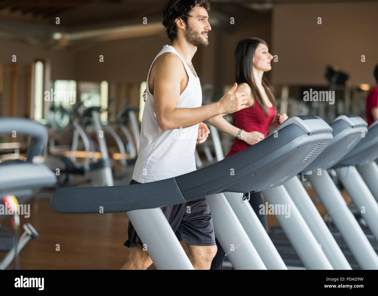People doing cardio workout on treadmills in a gym Stock Photo - Alamy