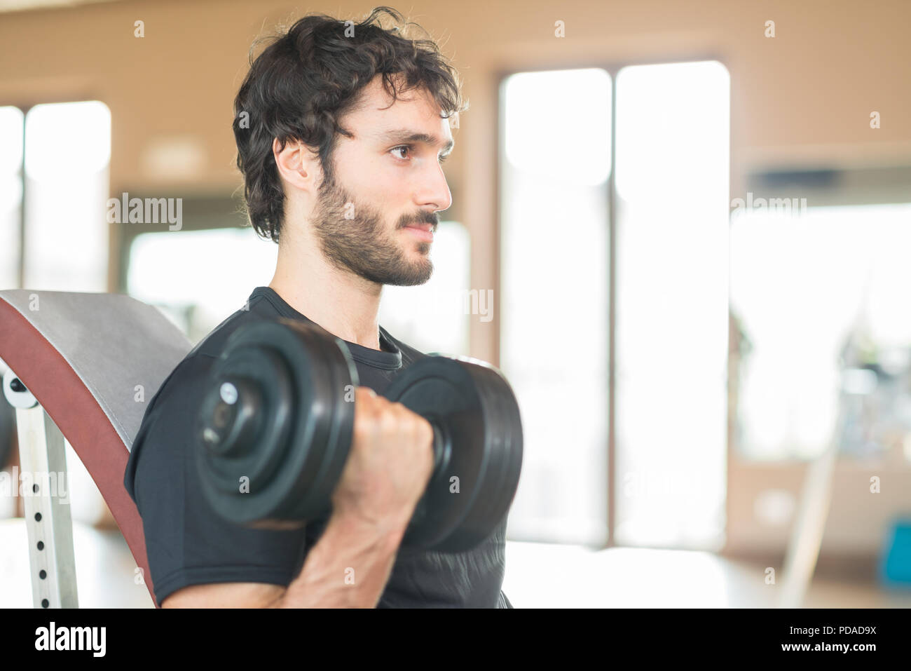 Bodybuilder using a dumbbell to work out Stock Photo - Alamy